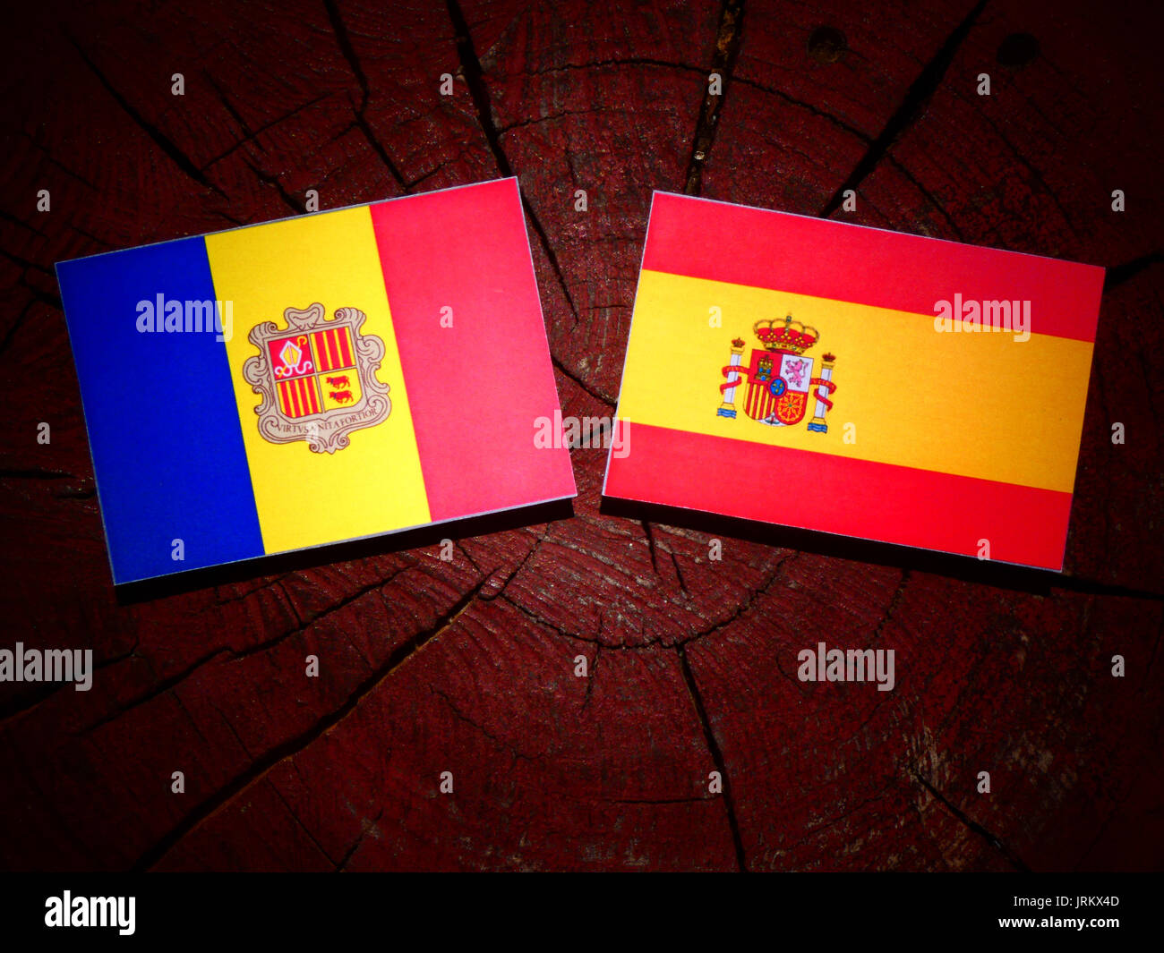 Andorra flag with Spanish flag on a tree stump isolated Stock Photo - Alamy
