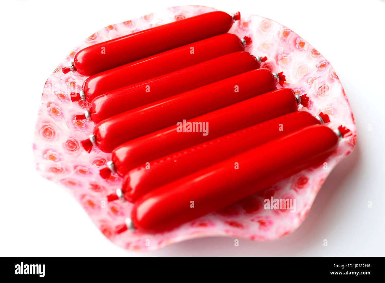 red sausage in pink plate Stock Photo - Alamy