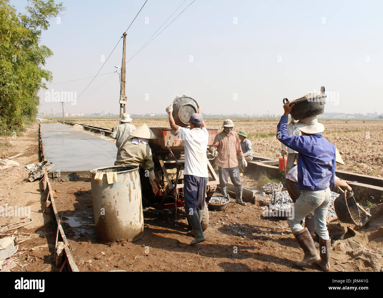 HAI DUONG, VIETNAM, AUGUST, 23: workers Repairing of concrete road in ...
