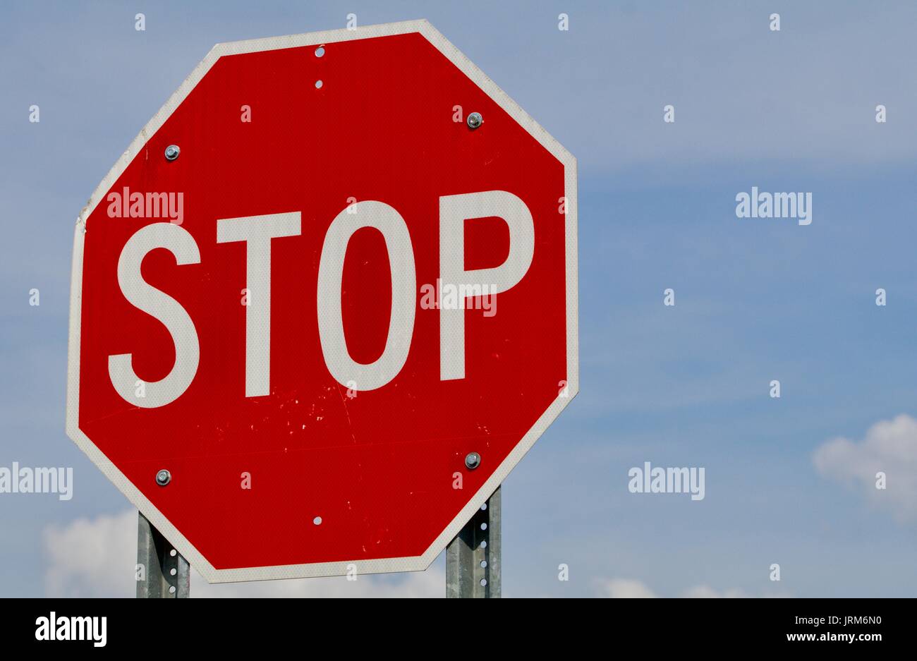 Blue sky, red stop sign Stock Photo - Alamy