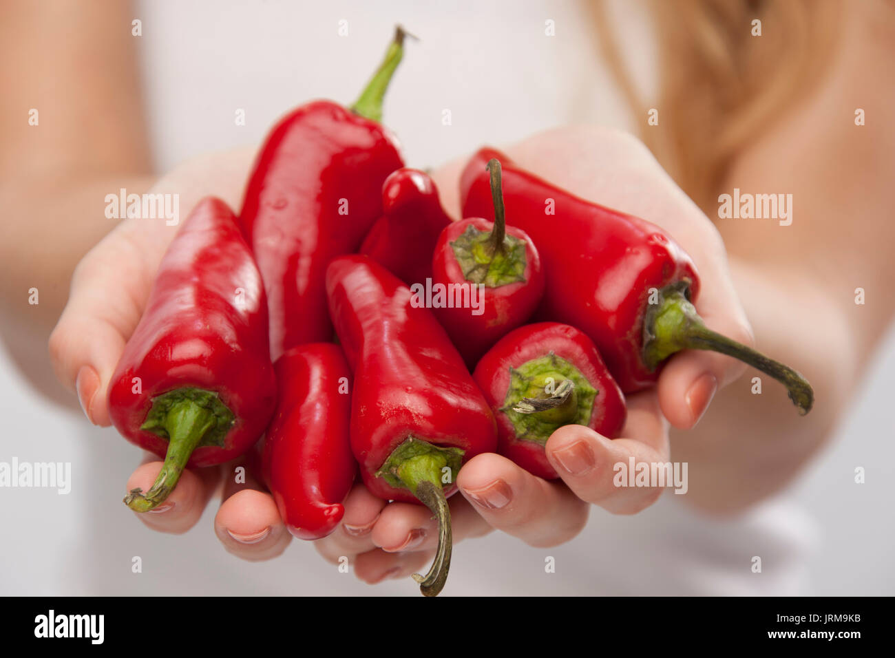 Hand full of chili peppers Stock Photo - Alamy