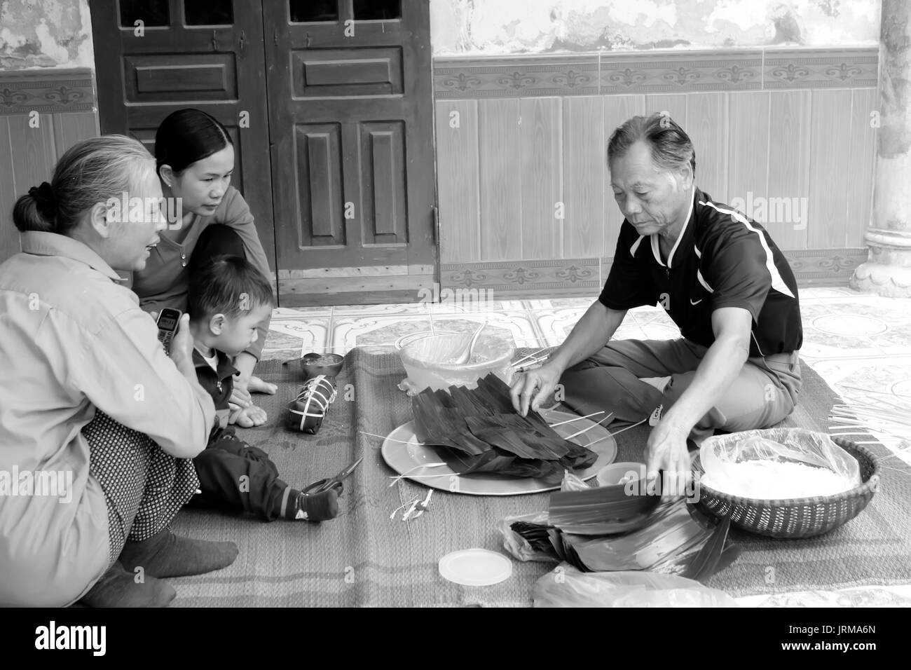 HAI DUONG, VIETNAM, November, 26: Asian man packing rice cake on ...