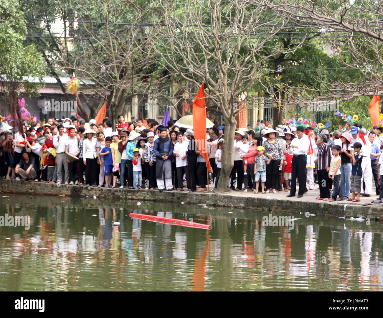 HAI DUONG, VIETNAM, April 12: group of people drop tree into the pond ...