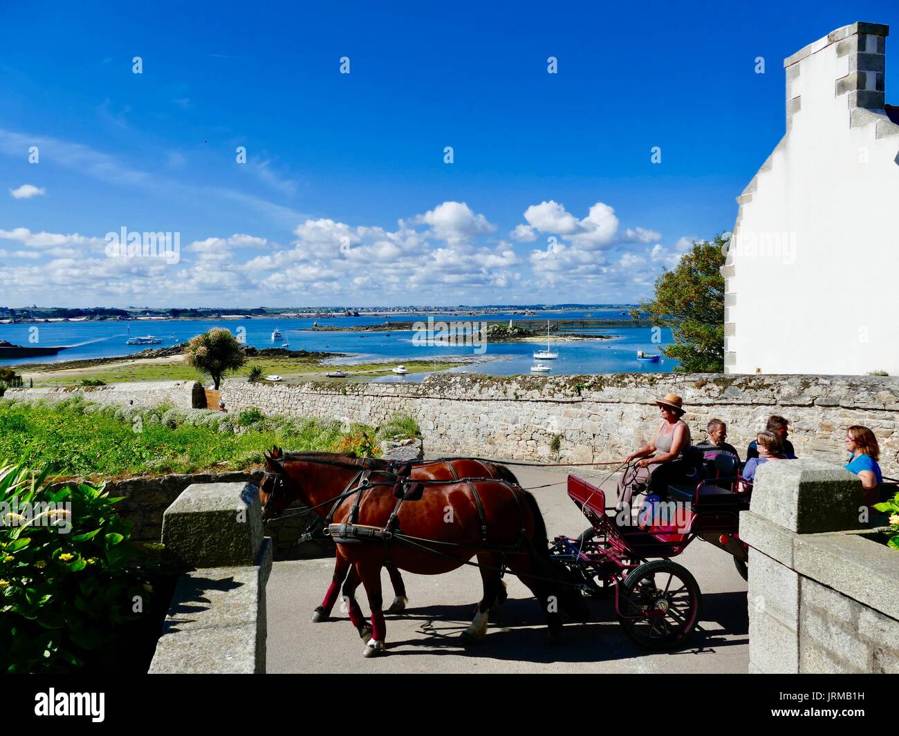 Tourists taking horse drawn carriage tour of Batz Island, Île de Batz ...