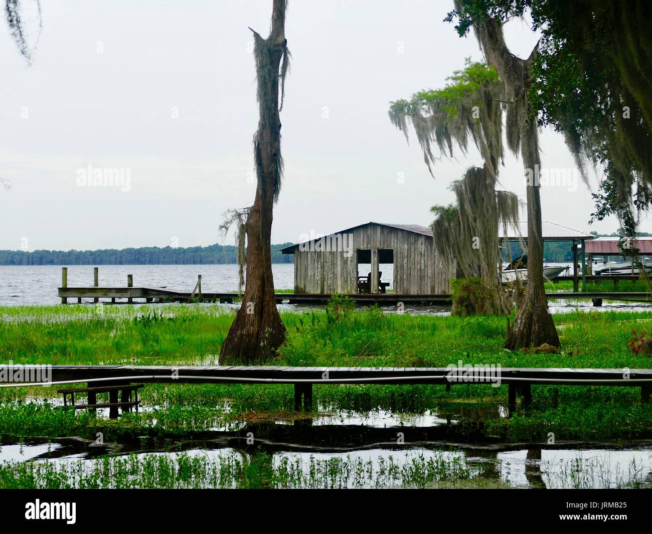 Docks and old, weathered dock house, boat house, on large lake with ...