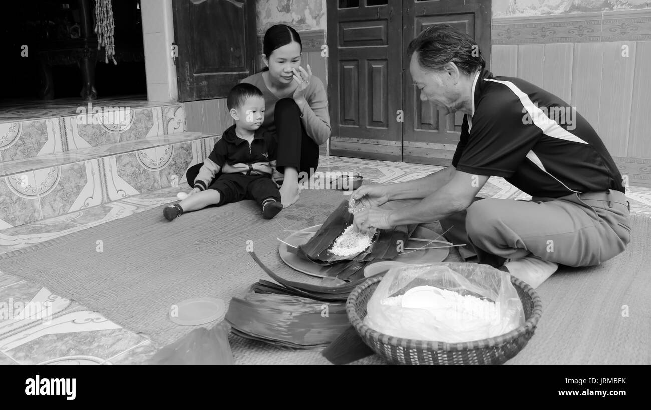 HAI DUONG, VIETNAM, November, 26: Asian man packing rice cake on ...