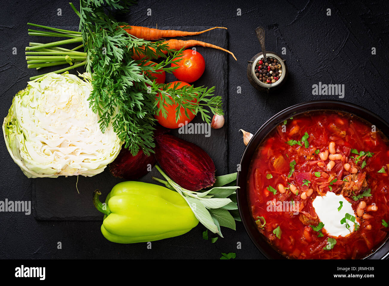 Traditional Ukrainian Russian borscht with white beans on the black ...