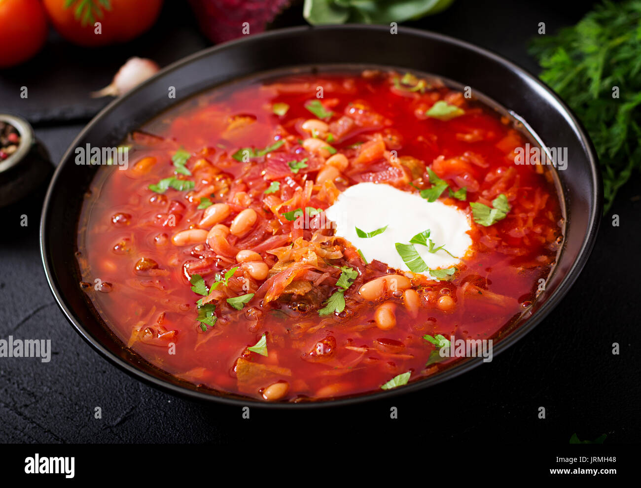 Traditional Ukrainian Russian borscht with white beans on the black ...