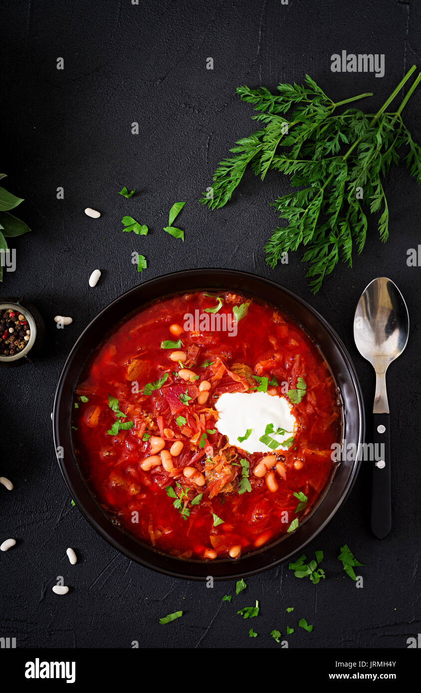 Traditional Ukrainian Russian borscht with white beans on the black ...