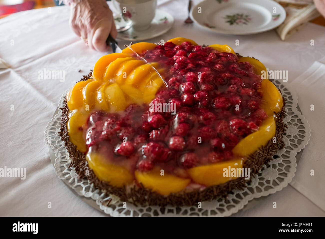 Fruit plane with rasperries and peach cutting with a knife Stock Photo ...