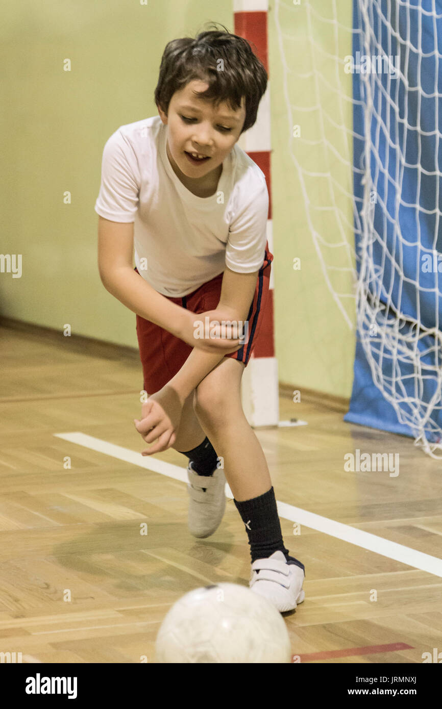 A boy playing football, havy training, boy running behind the ball ...