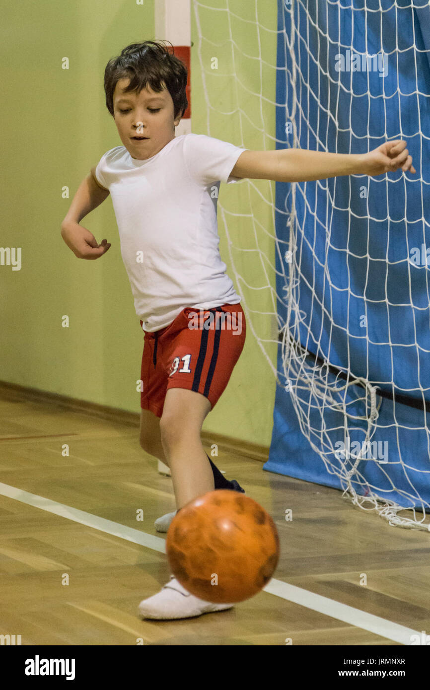 A boy playing football, havy training, boy running behind the ball ...