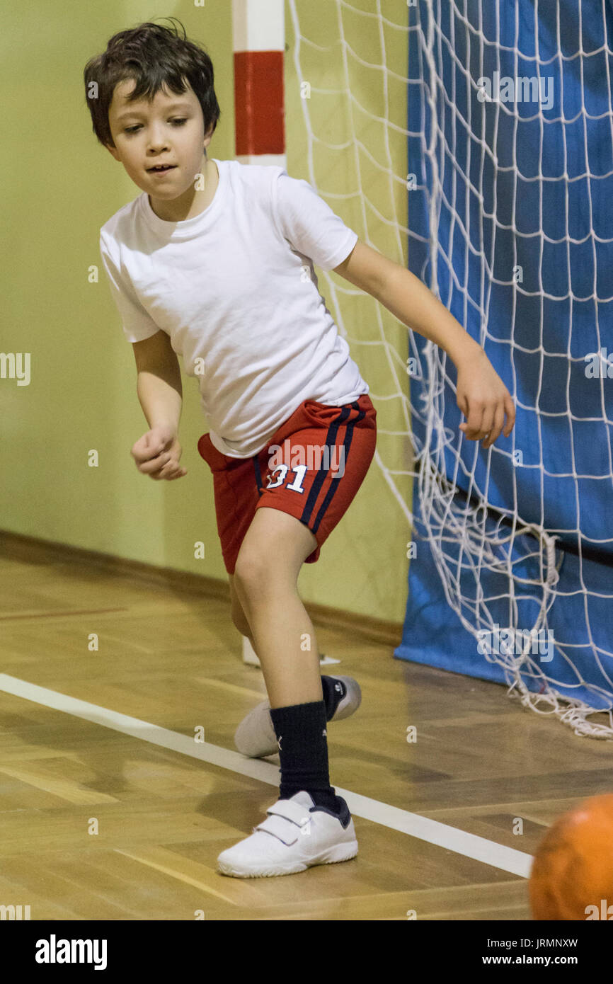 A boy playing football, havy training, boy running behind the ball ...