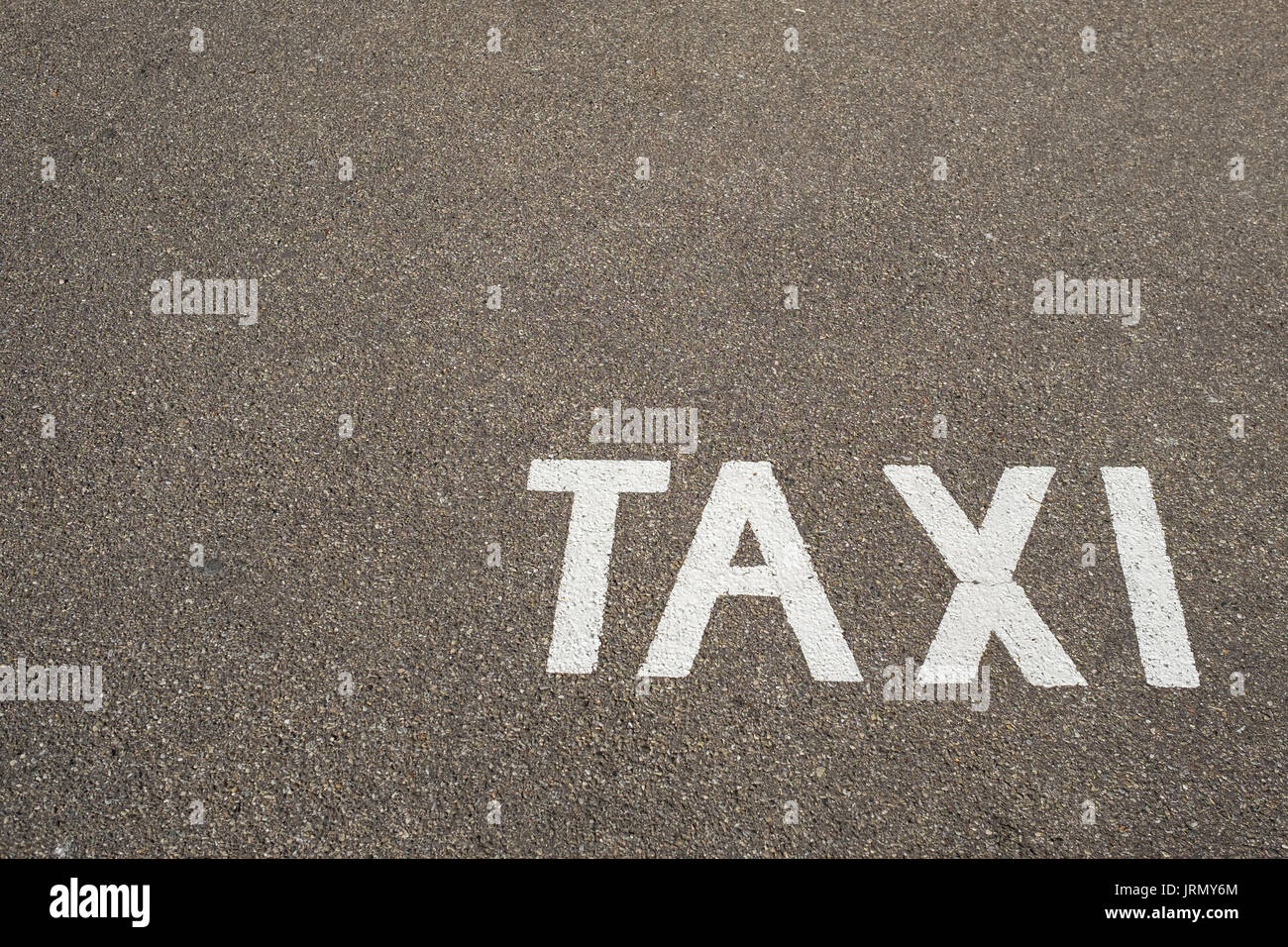 White letters taxi on a grey street Stock Photo - Alamy