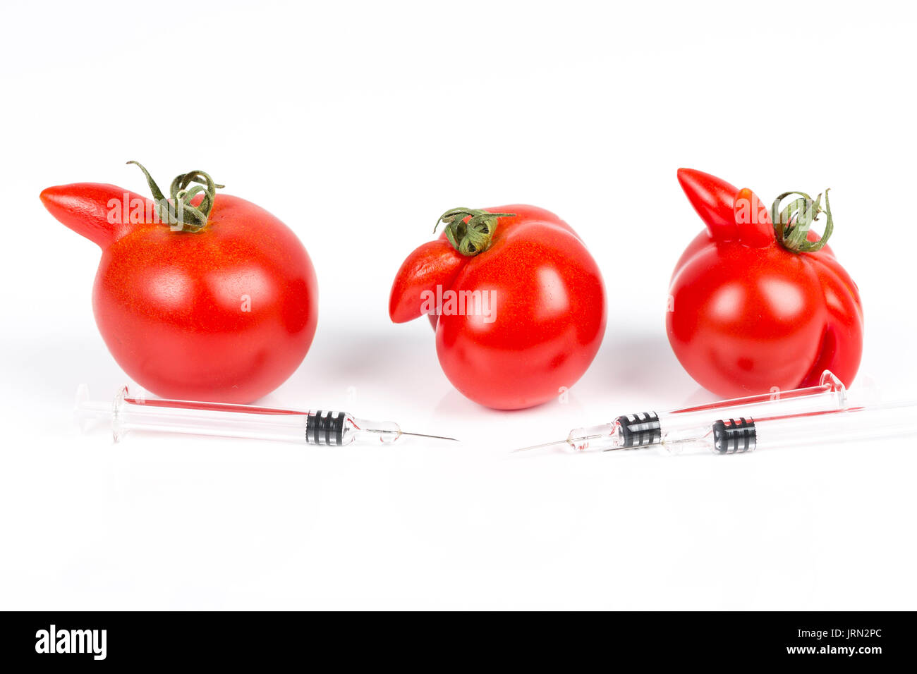 Tomatoes with deformation and defects, with syringe. Chemical treatment ...