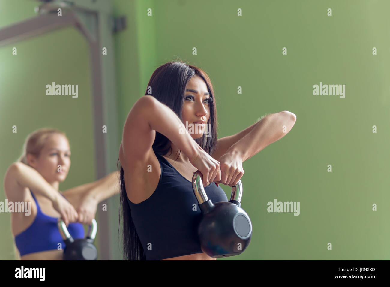 women with coach at kettlebell functional training in fitness center ...