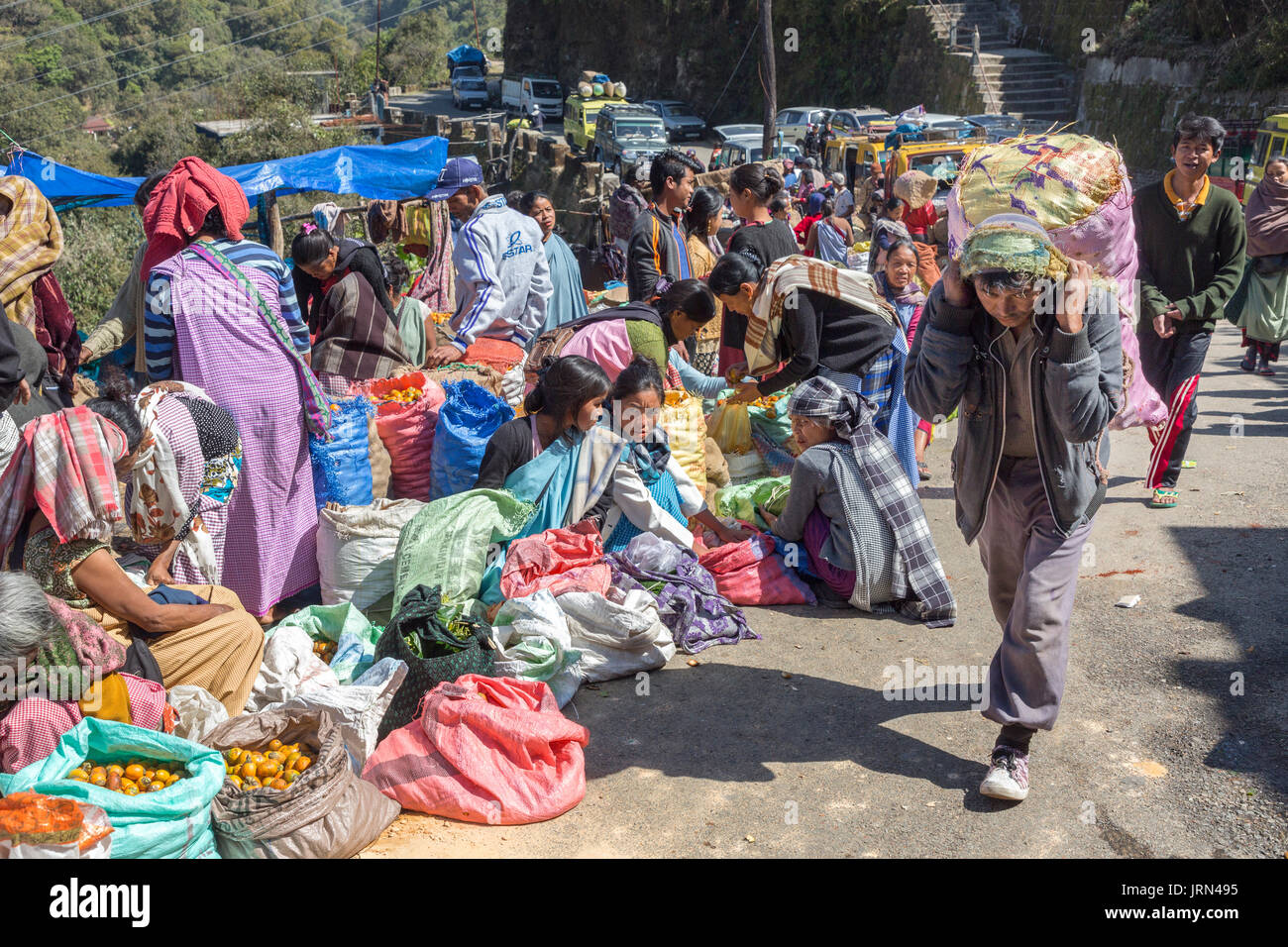 Man carrying sack through outdoor market area, Mawsynram, Meghalaya ...