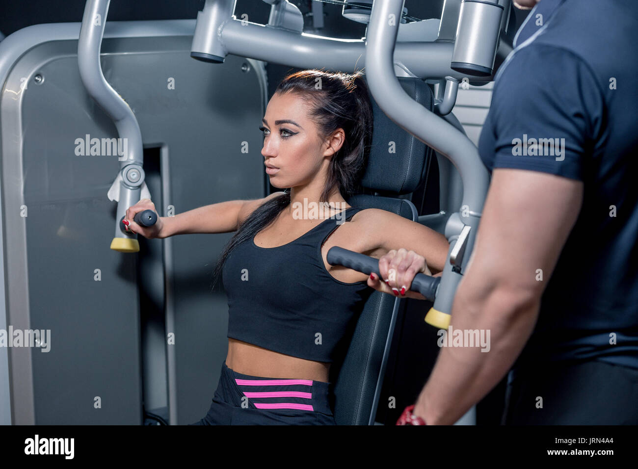 sport, fitness, teamwork and people concept - young woman flexing ...