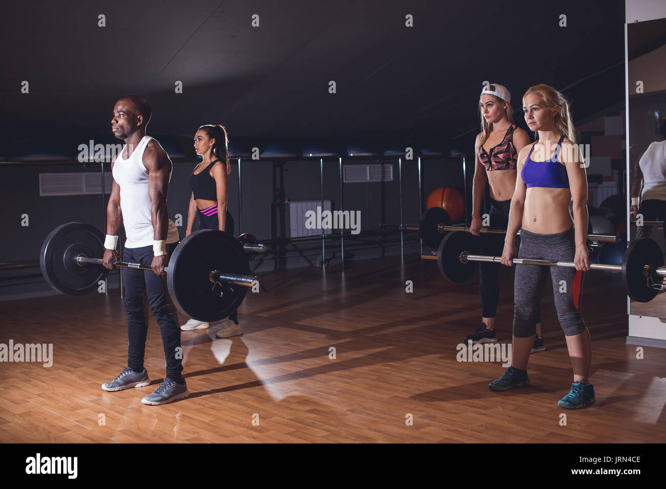 Barbell weight lifting group weightlifting workout exercise gym Stock ...