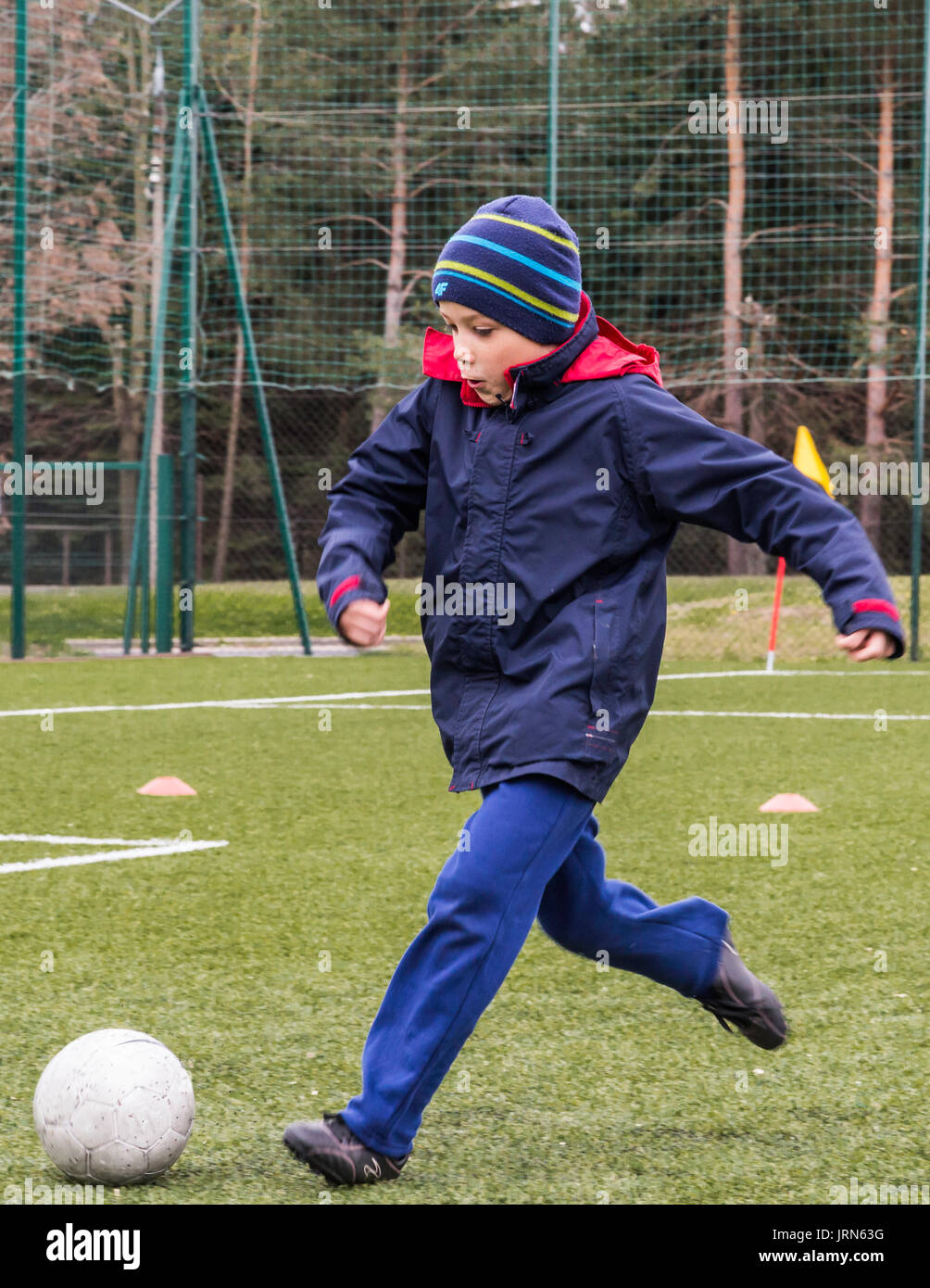A boy playing football, havy training, boy running behind the ball ...