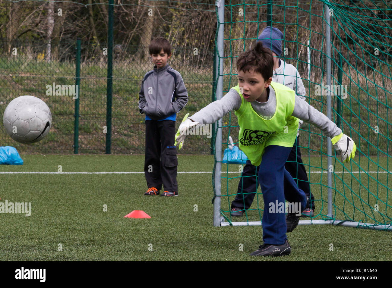 A boy playing football, havy training, boy running behind the ball ...
