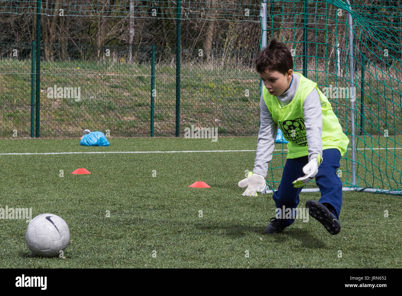 A boy playing football, havy training, boy running behind the ball ...