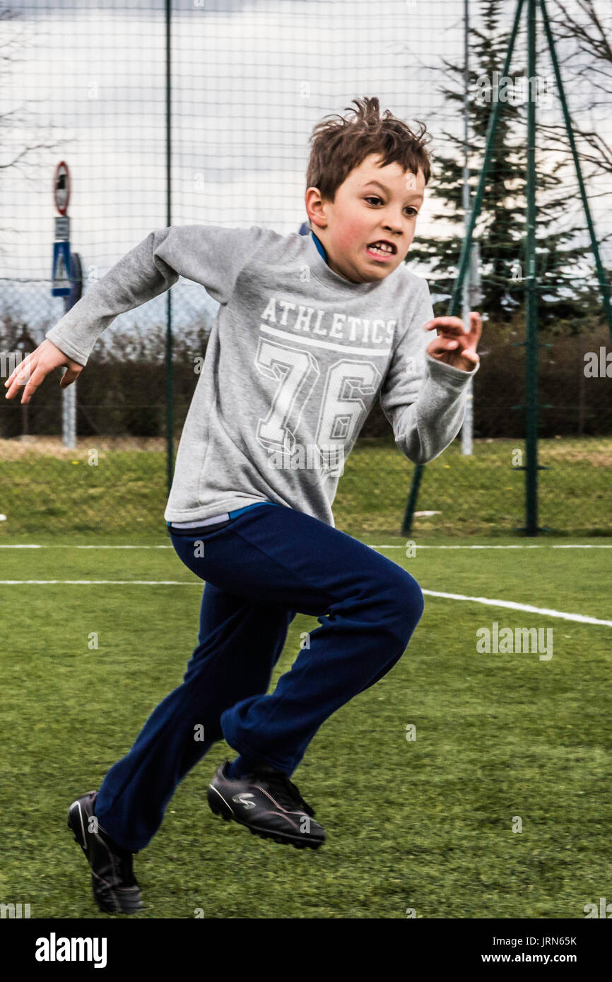 A boy playing football, havy training, boy running behind the ball ...