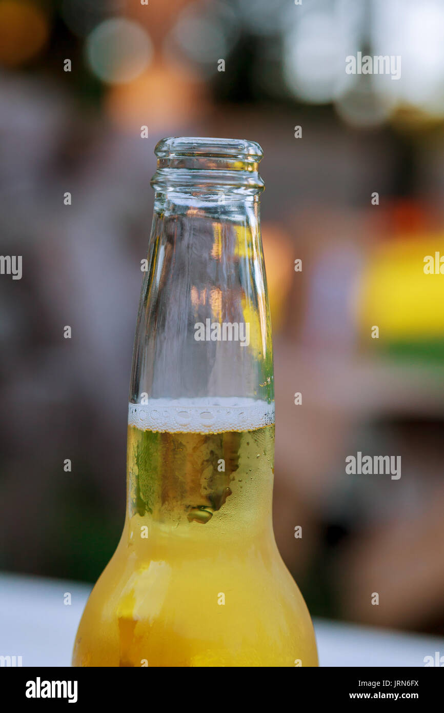 open bottle of beer on the background of nature Full open bottle of ...