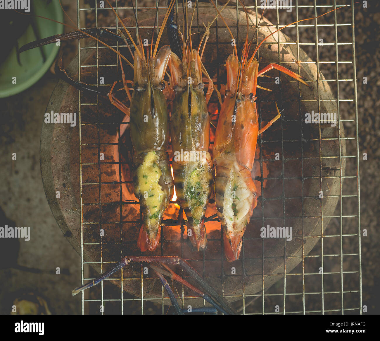 Grilled river prawns with butter and herb on flaming grill Stock Photo ...