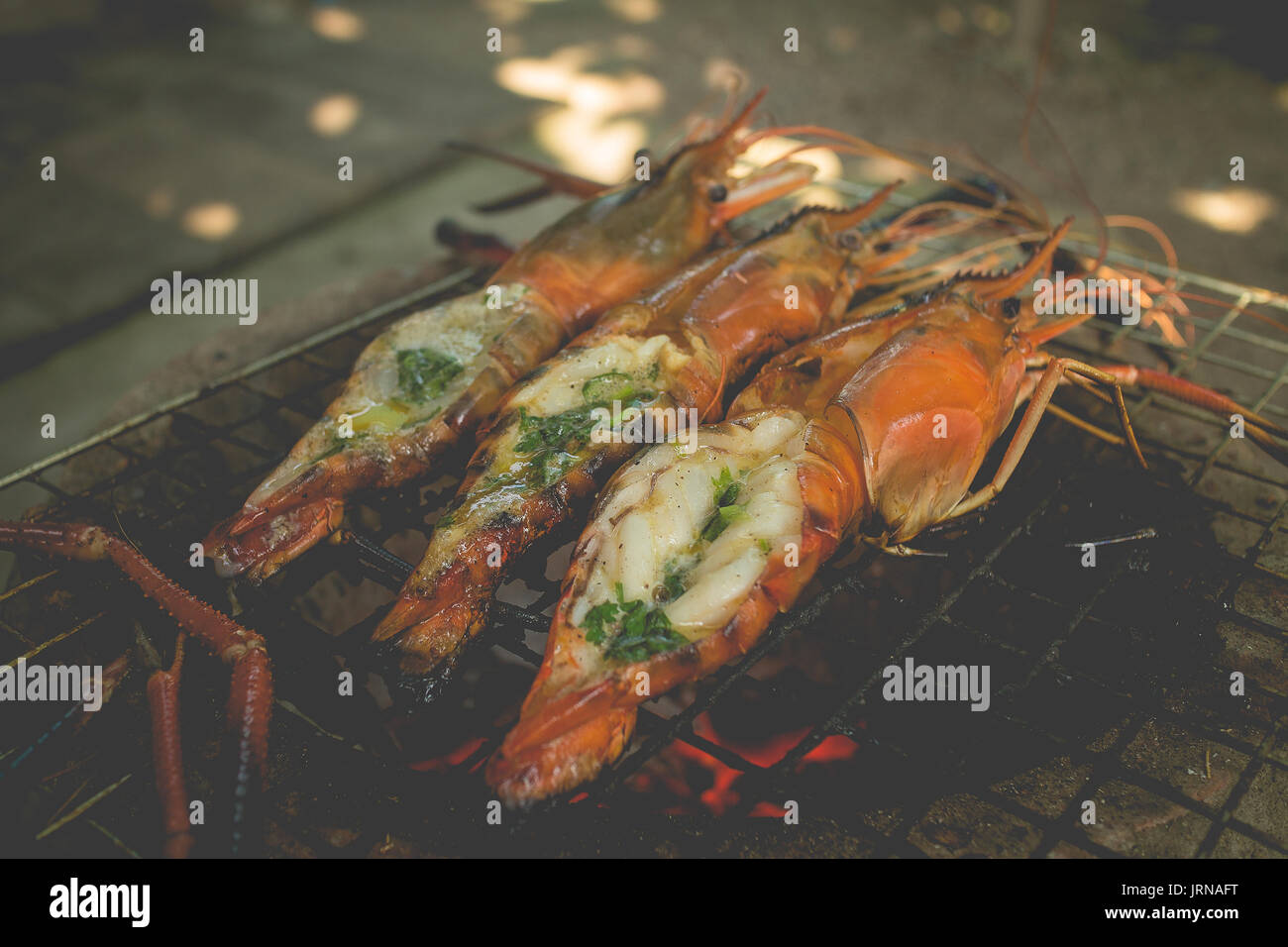 Grilled river prawns with butter and herb on flaming grill Stock Photo ...