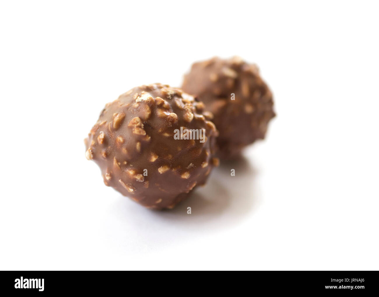 Chocolate balls are praline and shallow focus isolated on white ...