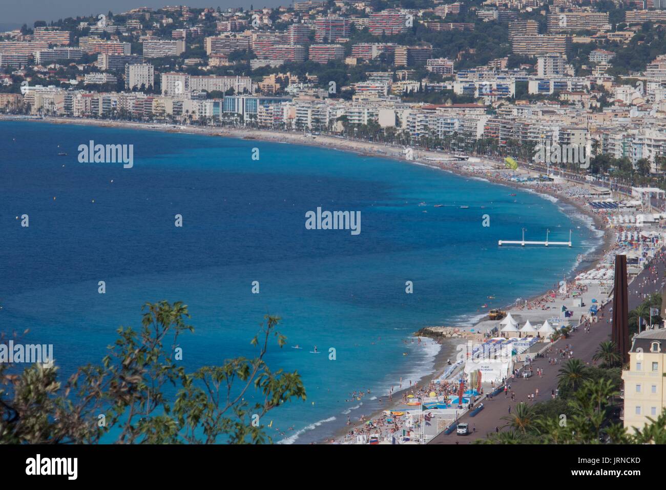 Distant view of seafront hotels and crowds of tourists on beach, Nice ...