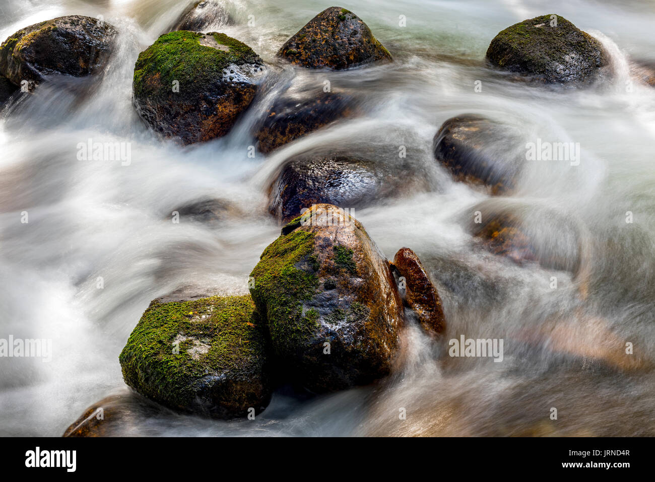 Textures with in the flow of waters as it routs around rocks Stock ...