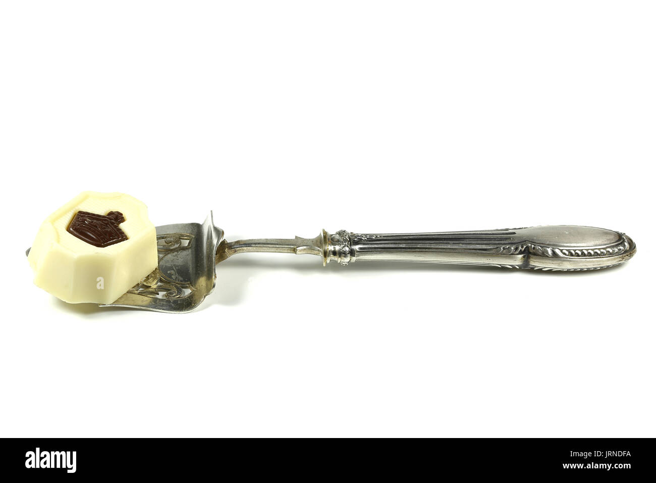 silver spoon with Belgian chocolate praline isolated on white ...