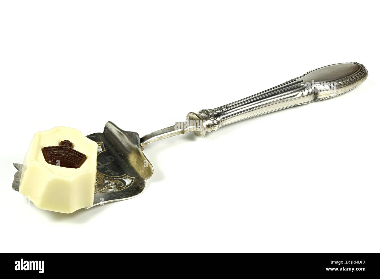 silver spoon with Belgian chocolate praline isolated on white ...