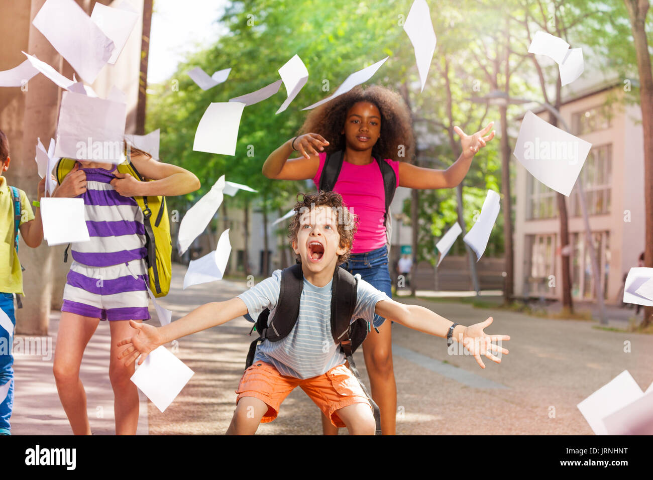 Shocked screaming very happy boy with school mates friends and flying ...