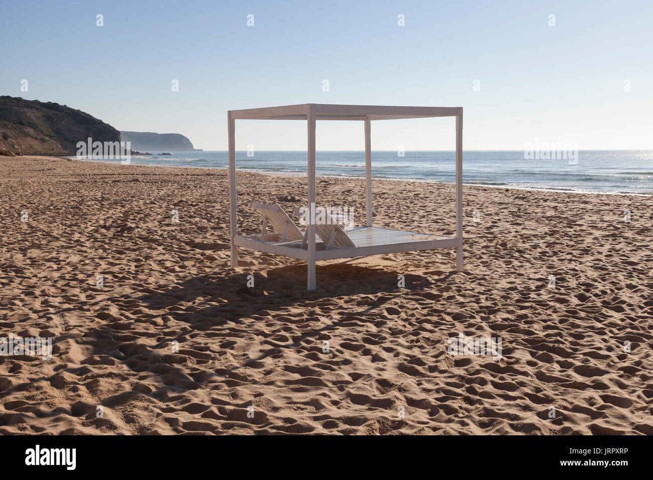 Salema, Portugal: Empty canopy lounge chair along Praia da Salema Stock ...