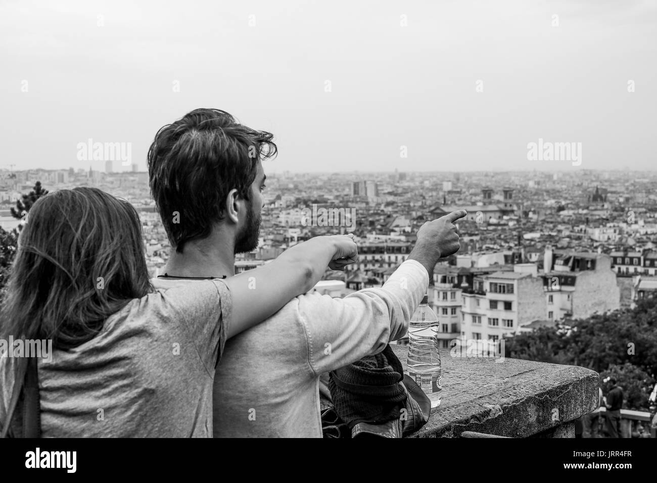 Young couple enjoying the view over Paris from Montmartre - PARIS ...