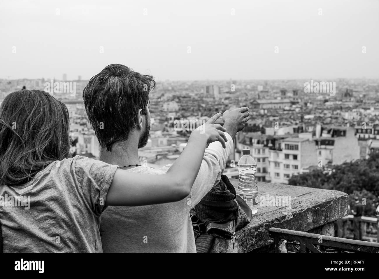 Young couple enjoying the view over Paris from Montmartre - PARIS ...