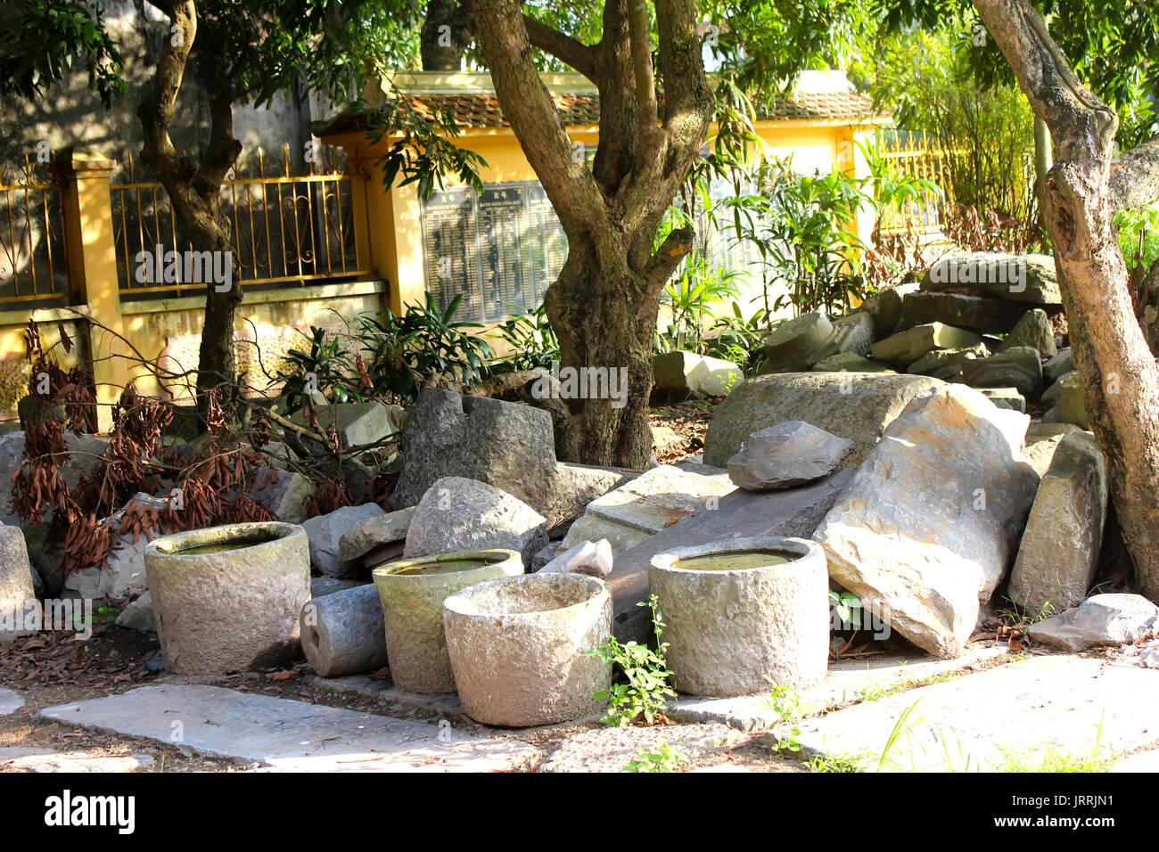 Old stone mortar for Rice processing in vietnam Stock Photo - Alamy