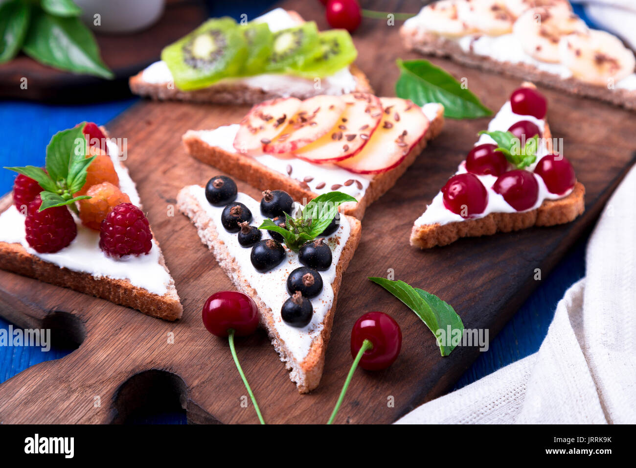 Fruit toast on wooden board on blue rustic background. Healthy ...