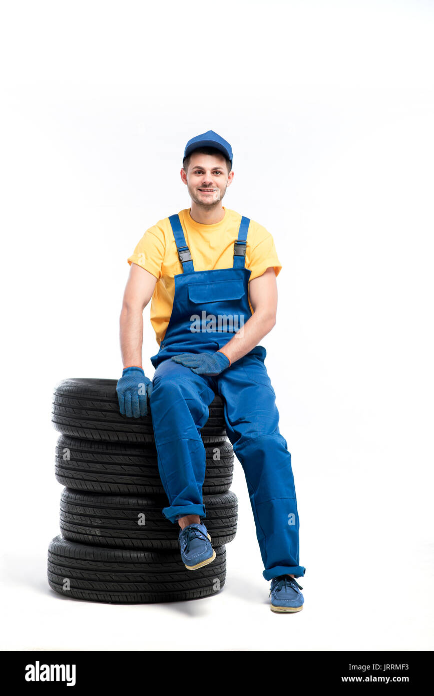 Tire serviceman isolated on white background, repairman with tyres ...
