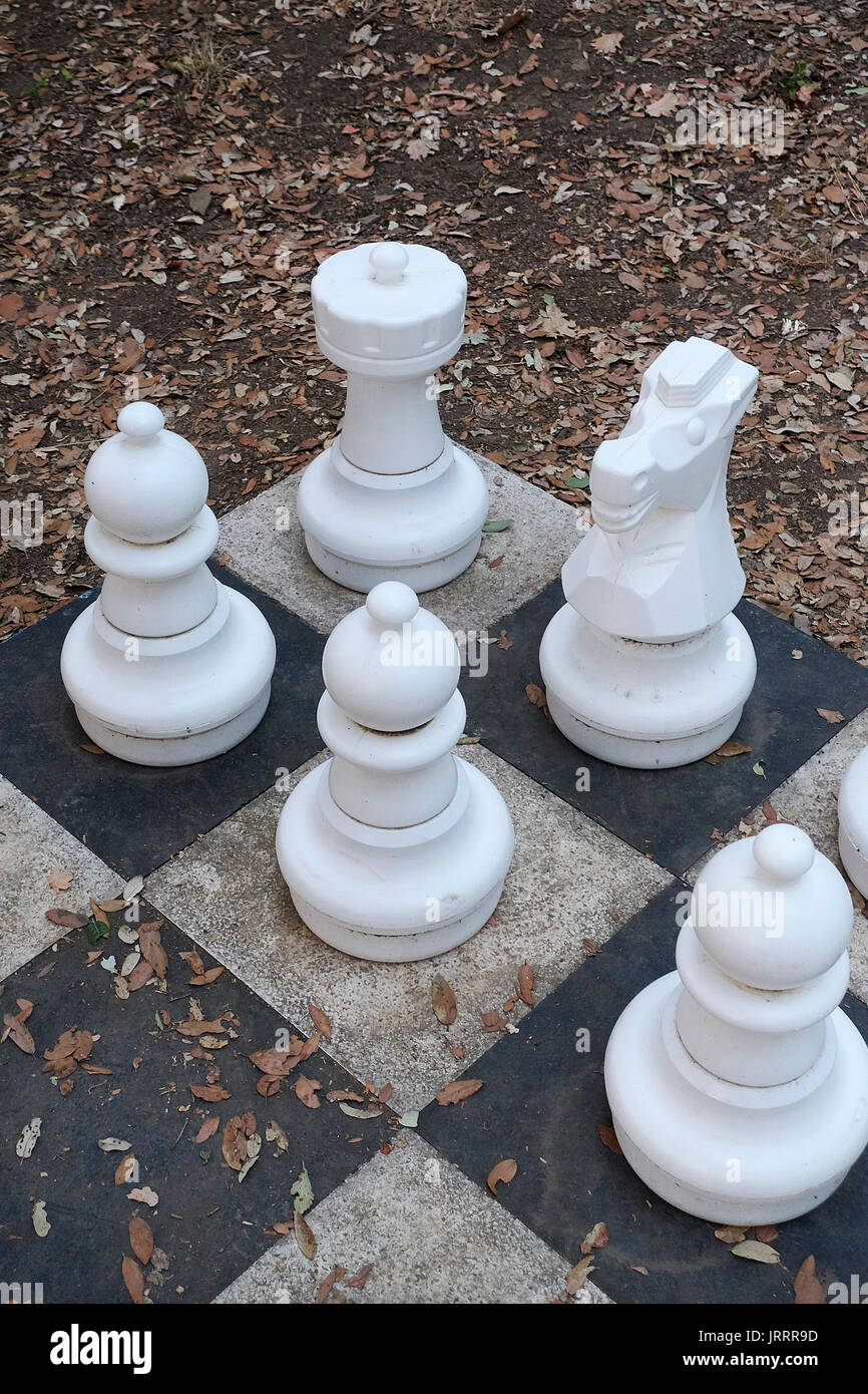 outdoor chess game with big pawns in the ground in a public park Stock ...