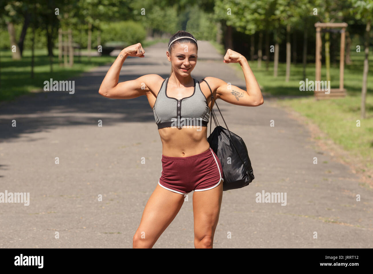 Young fitness woman after workout in the park Stock Photo - Alamy