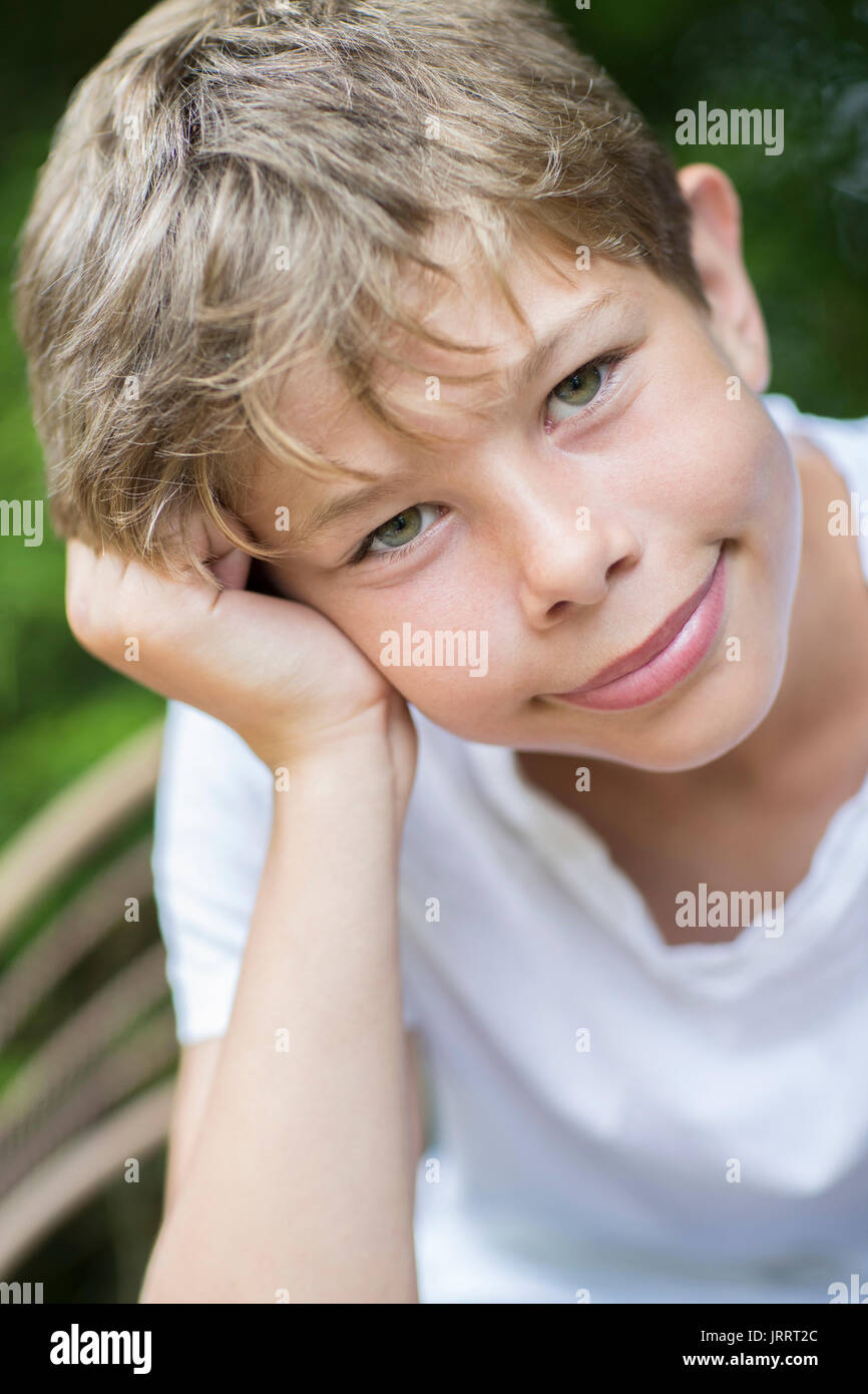 Portrait Of Happy Boy Sitting Outdoors Stock Photo - Alamy