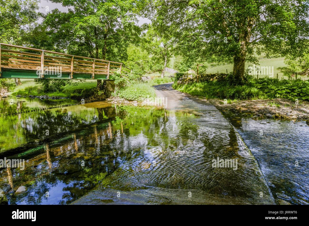 Footbridge and ford on a stream in a wooded area Stock Photo - Alamy