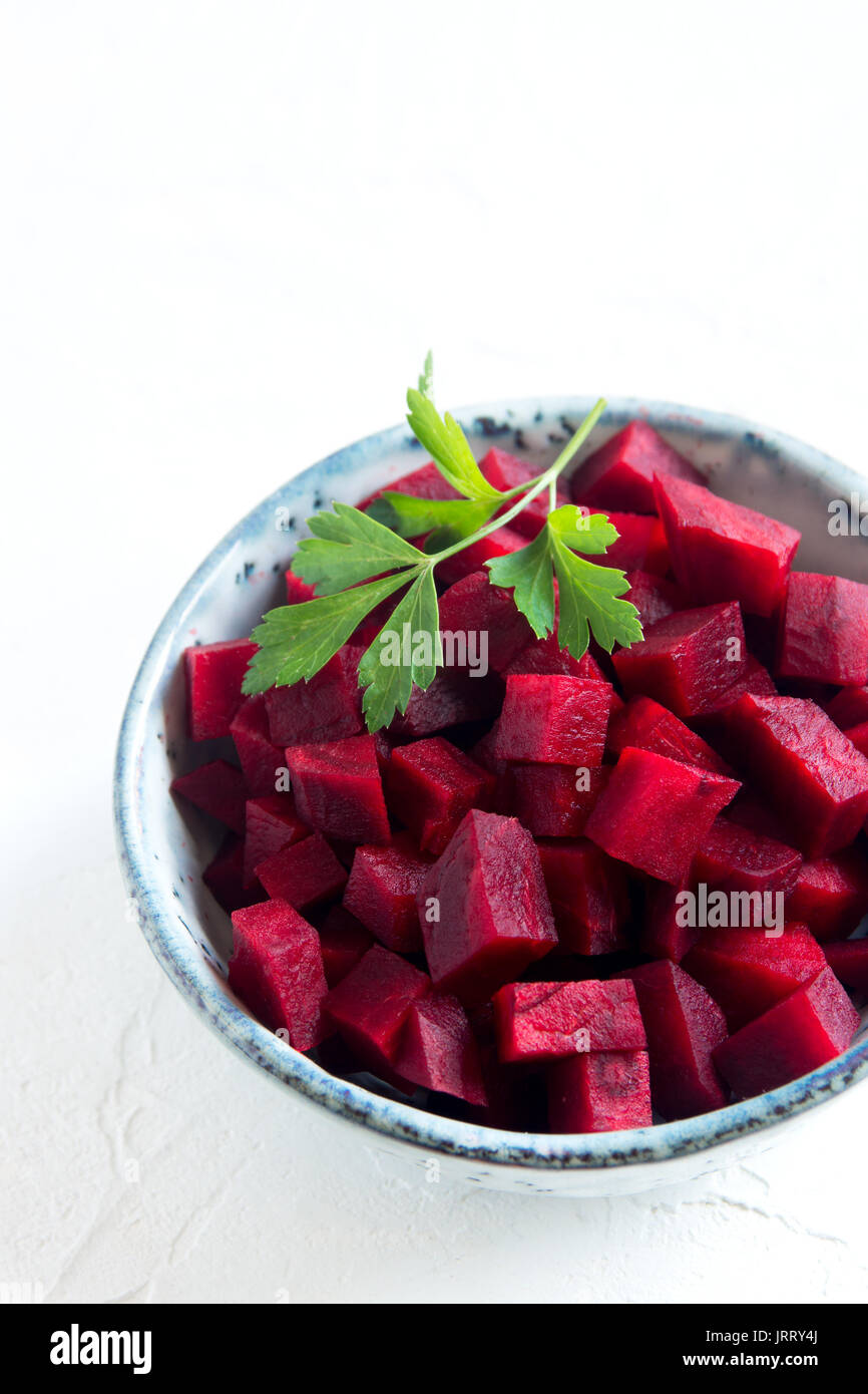 Beetroot (beet) chopped for salad in bowl over white background with ...
