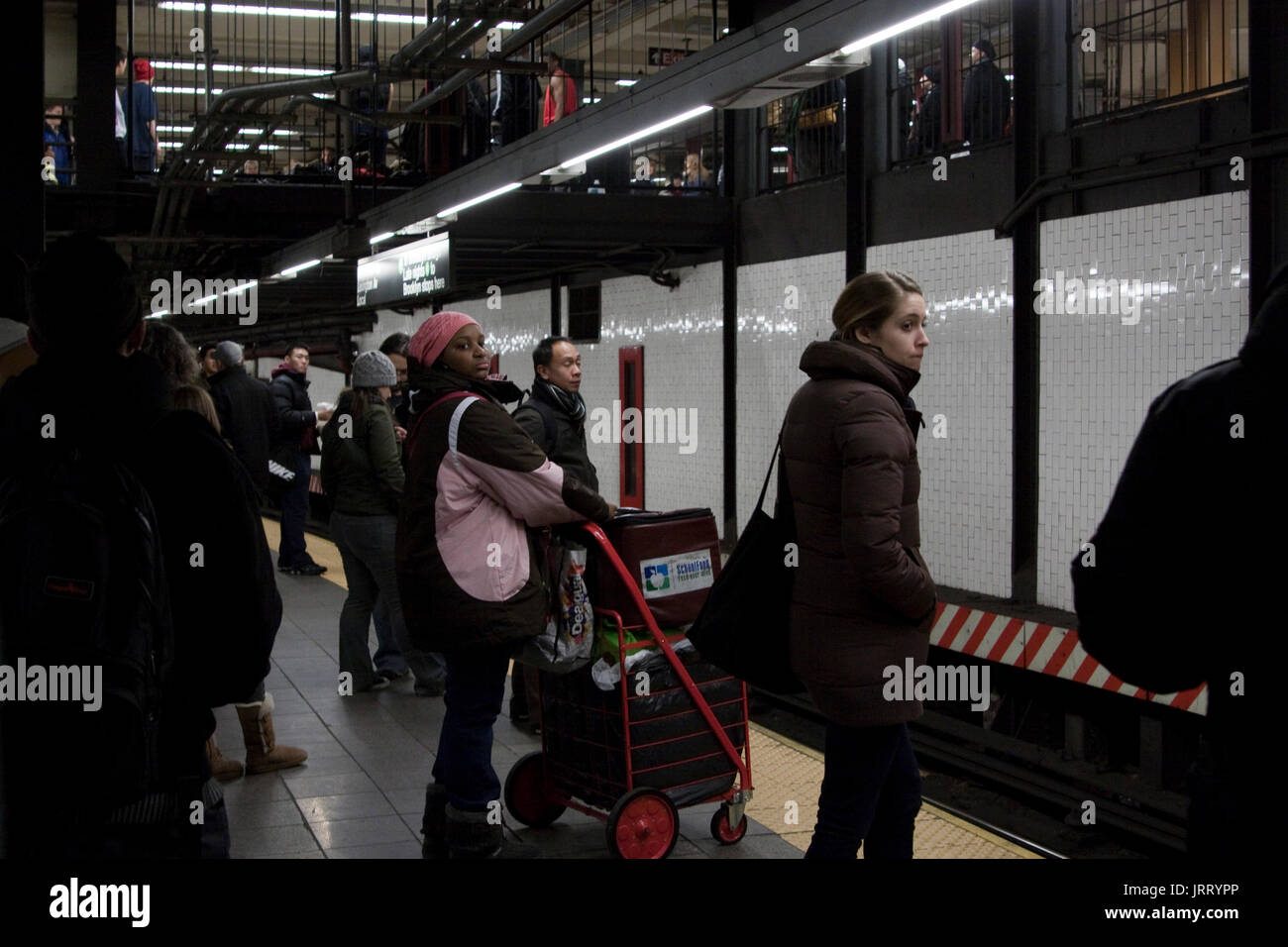 Passengers waiting on subway platform Stock Photo - Alamy