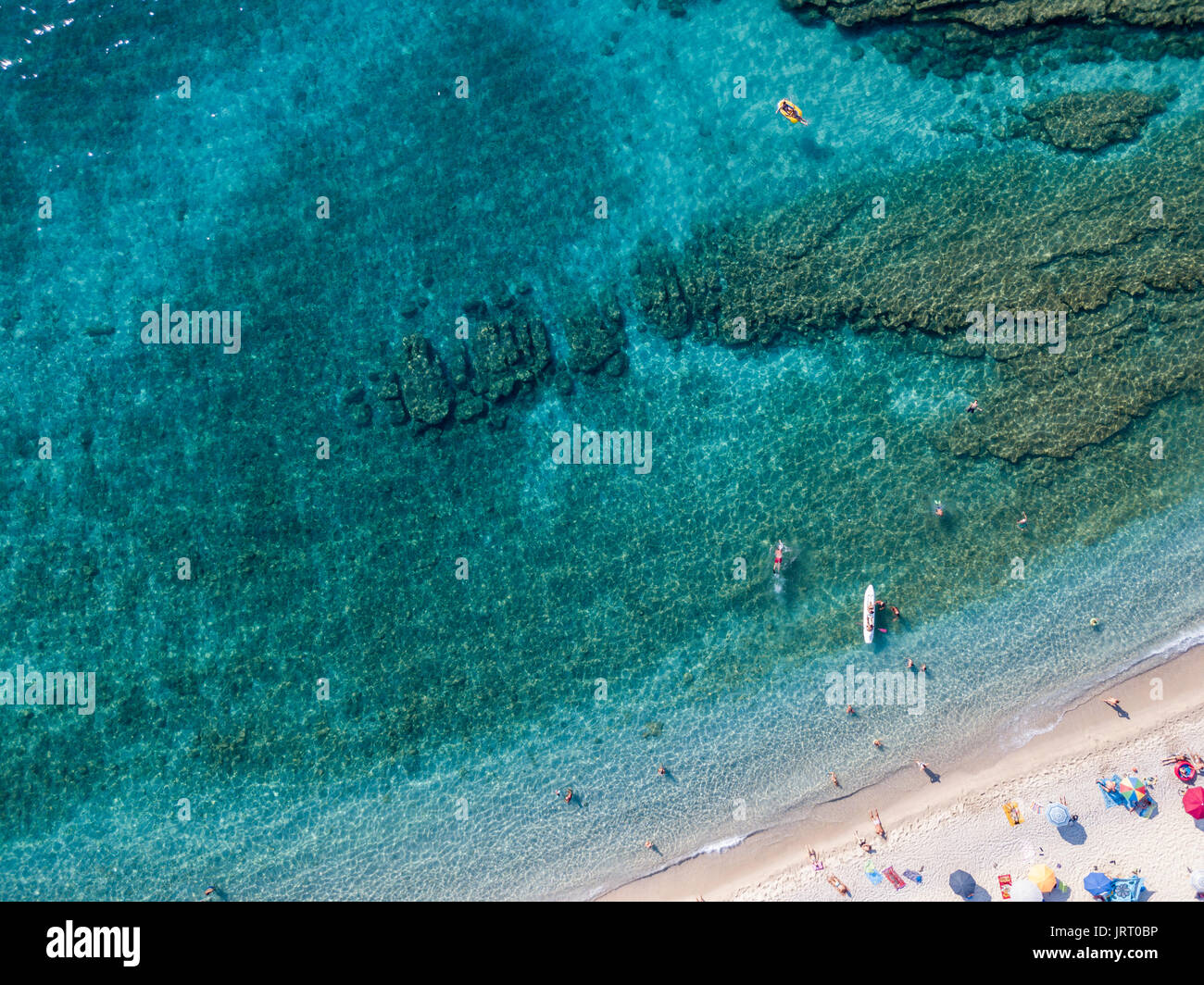 Aerial view of a canoe in the water floating on a transparent sea ...
