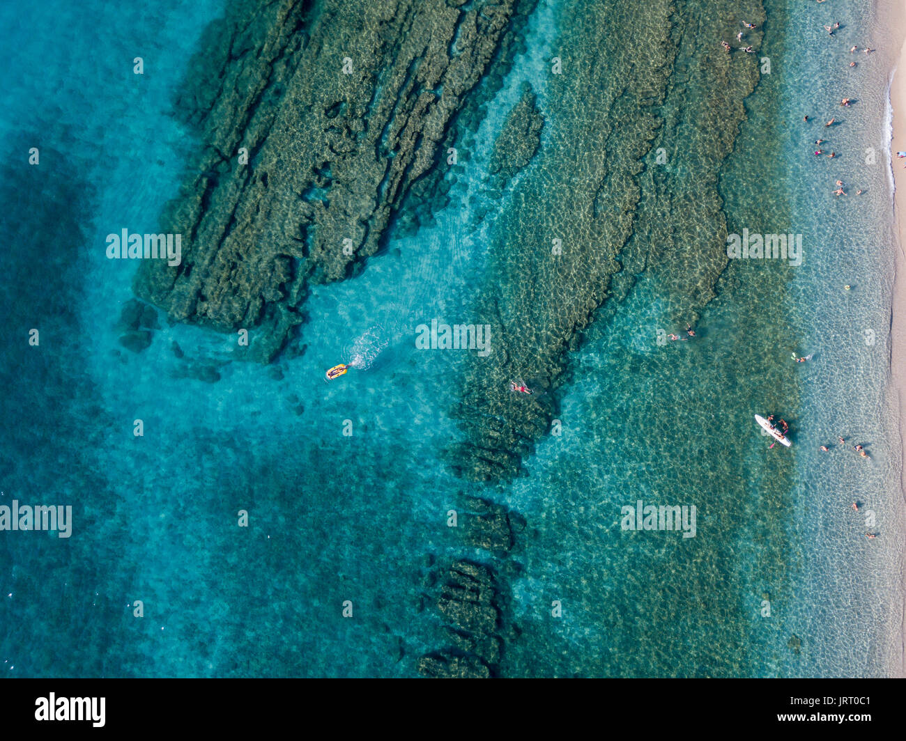 Aerial view of a canoe in the water floating on a transparent sea ...